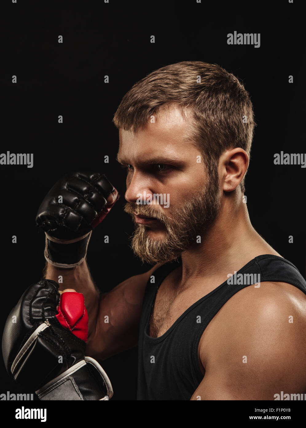 Athletic bearded boxer with gloves on a dark background Stock Photo - Alamy