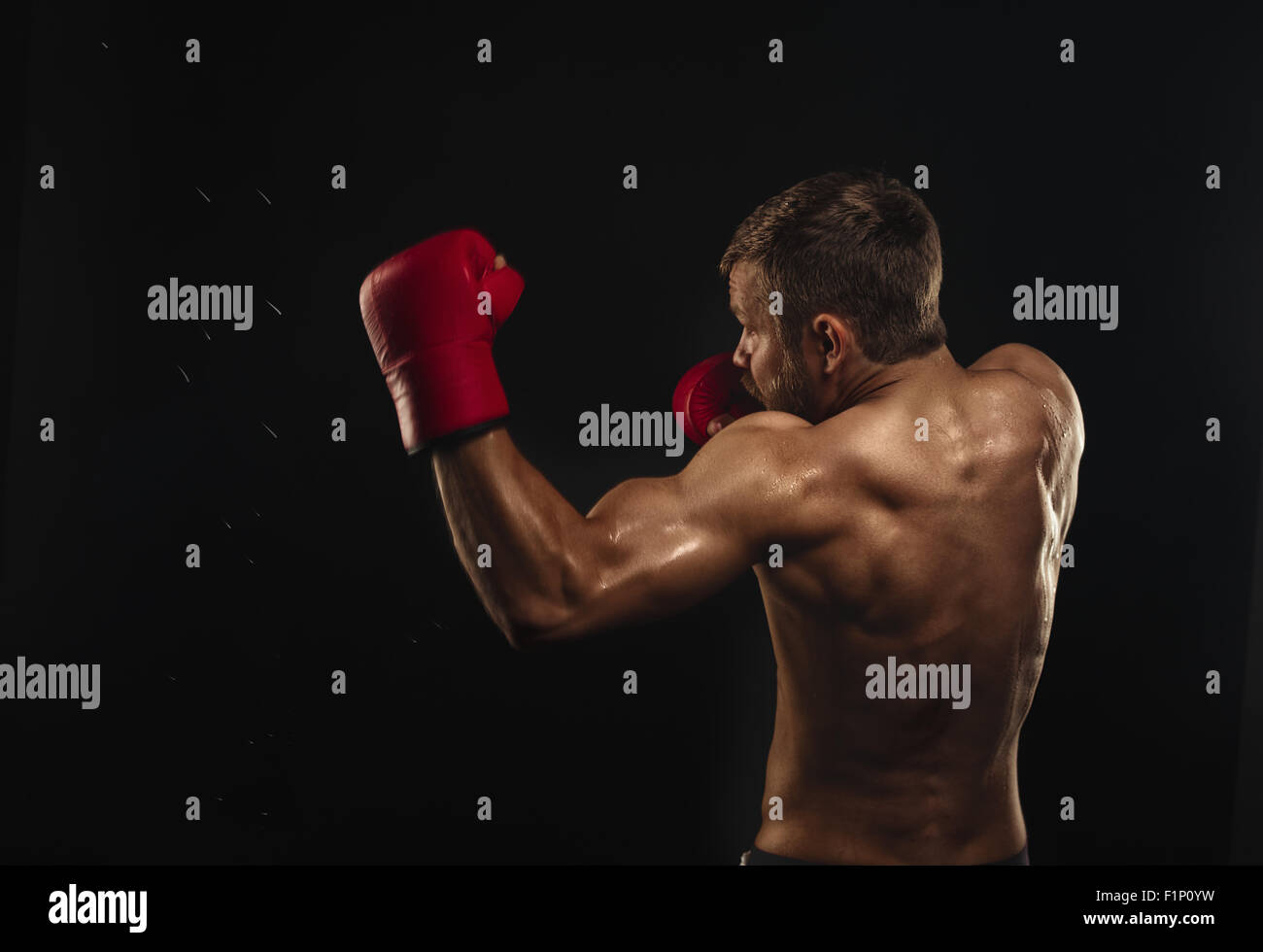 Athletic bearded boxer with gloves on a dark background Stock Photo - Alamy