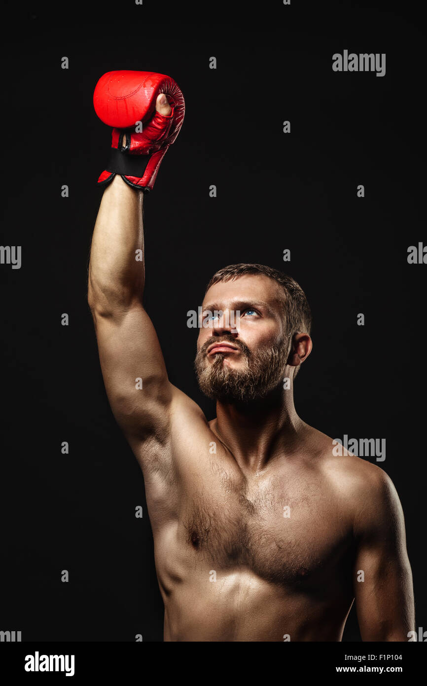 Athletic bearded boxer with gloves on a dark background Stock Photo - Alamy