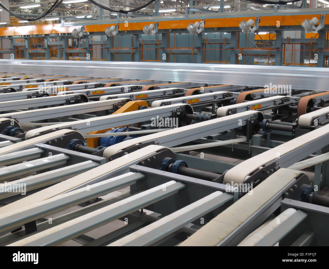 Aluminum lines on a conveyor belt in a factory Stock Photo - Alamy