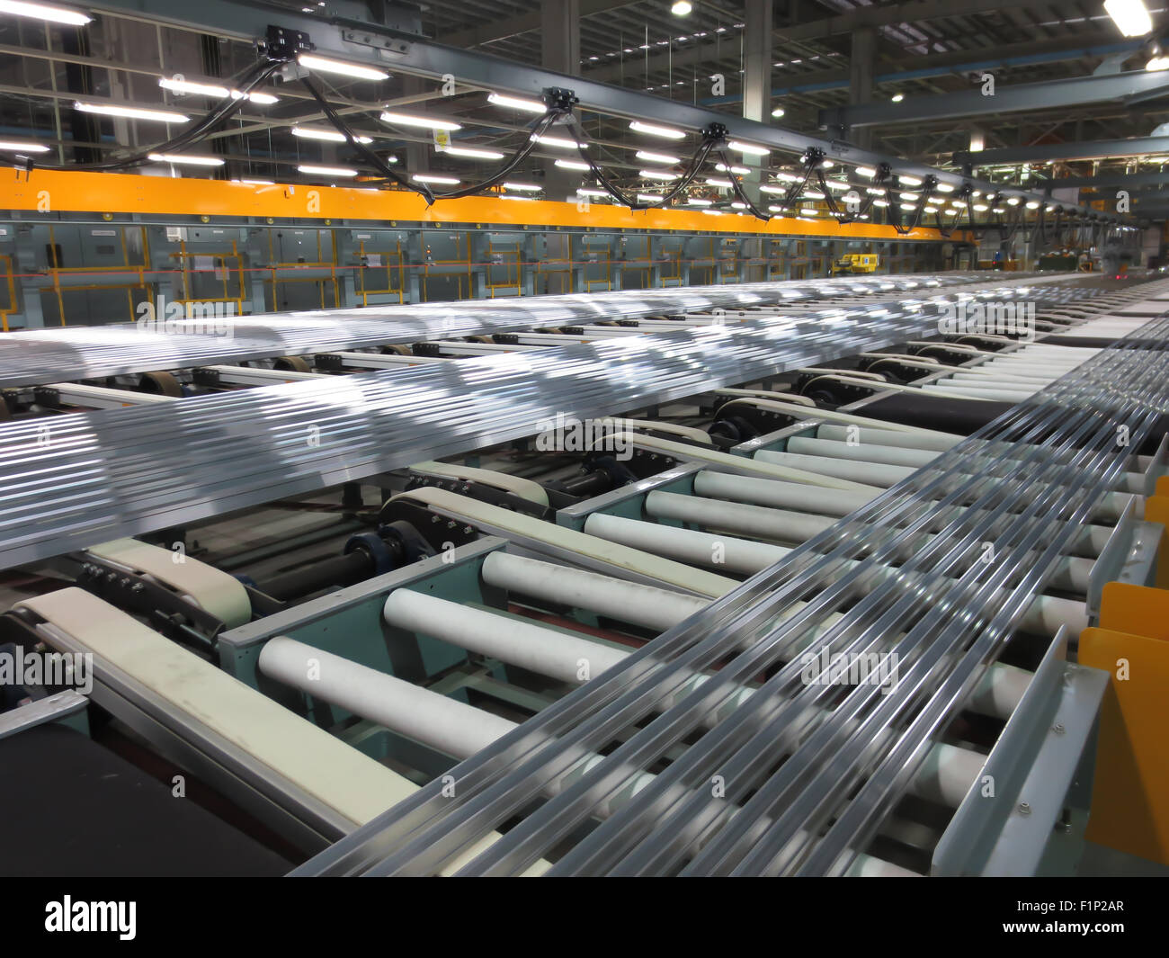 Aluminum lines on a conveyor belt in a factory Stock Photo - Alamy