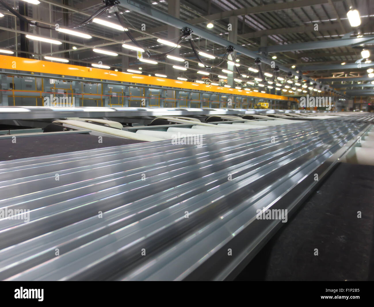 Aluminum lines on a conveyor belt in a factory Stock Photo - Alamy