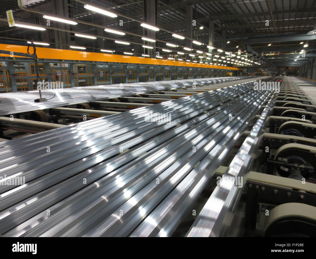 Aluminum lines on a conveyor belt in a factory Stock Photo - Alamy