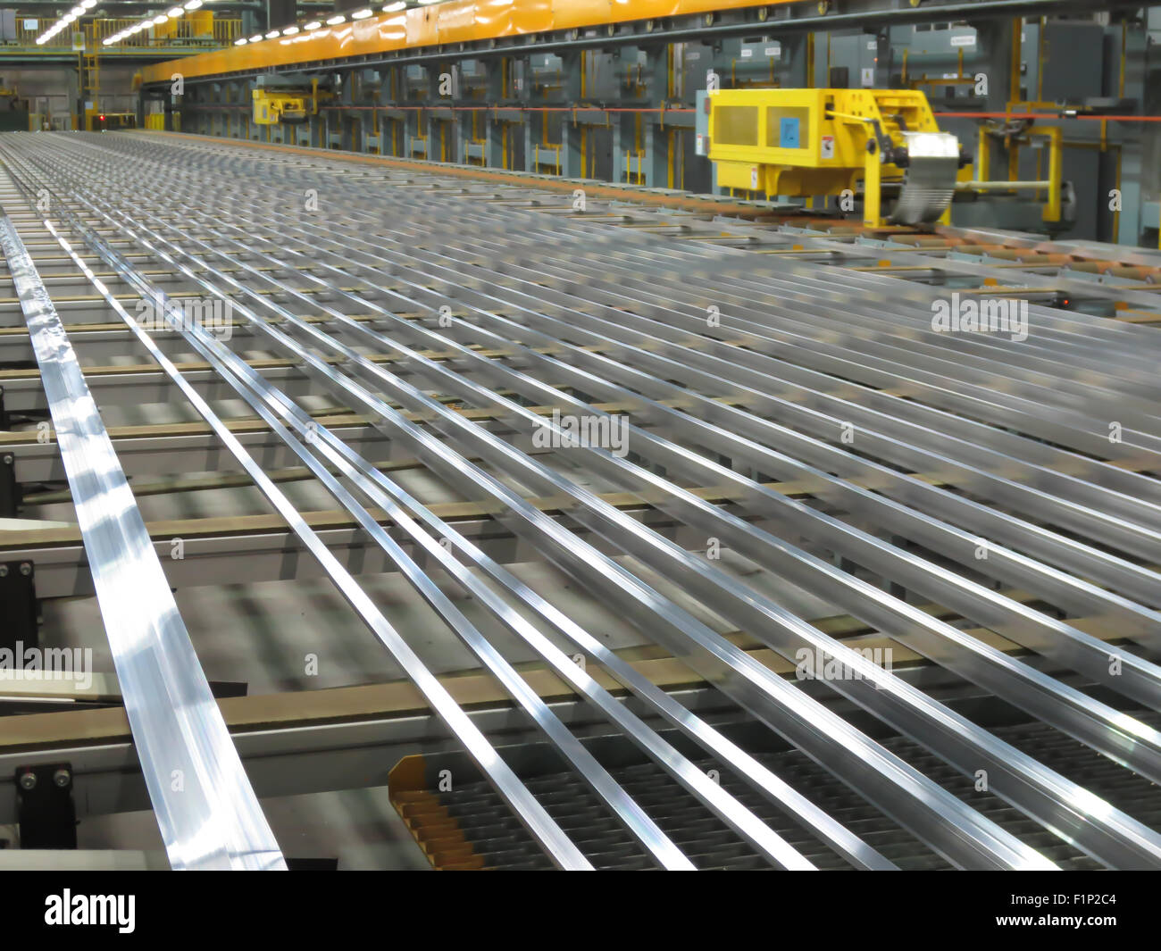 Aluminum lines on a conveyor belt in a factory Stock Photo - Alamy