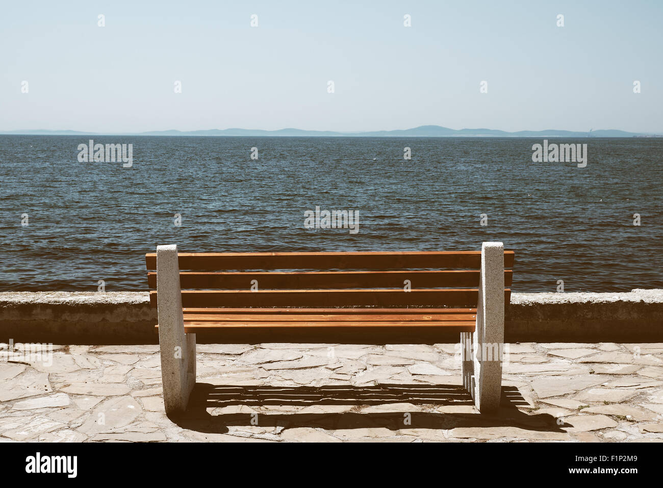 Bench near sea in retro style Stock Photo - Alamy