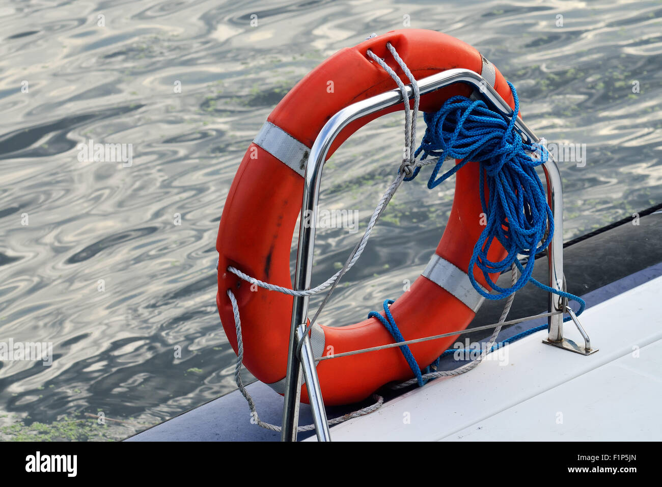 Red lifebuoy ring on board boats closeup Stock Photo - Alamy