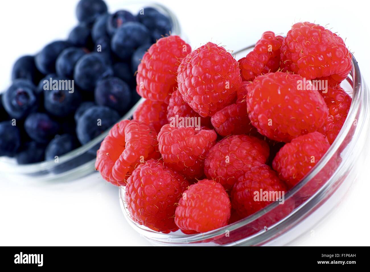 Raspberries and Blueberries Fruits in Glass Bowls. Fresh Raspberry ...