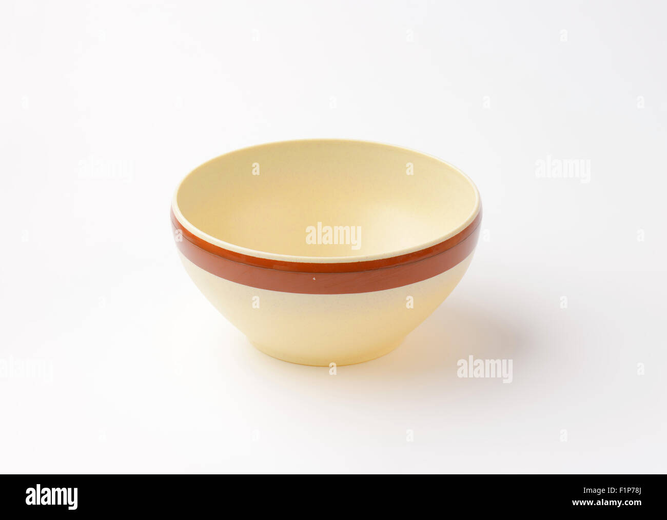beige bowl with brown stripe on white background Stock Photo - Alamy