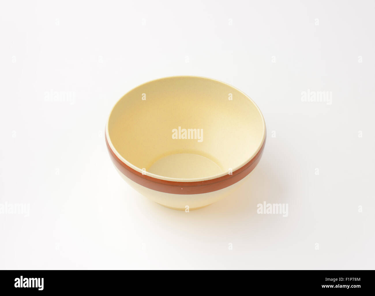 beige bowl with brown stripe on white background Stock Photo - Alamy