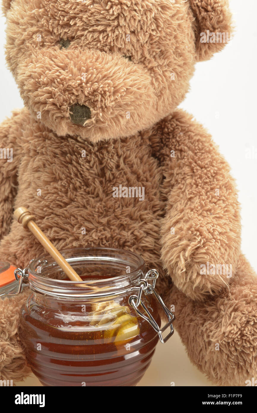 Teddy bear with a jar of sweet flower honey and wooden drizzler stick ...