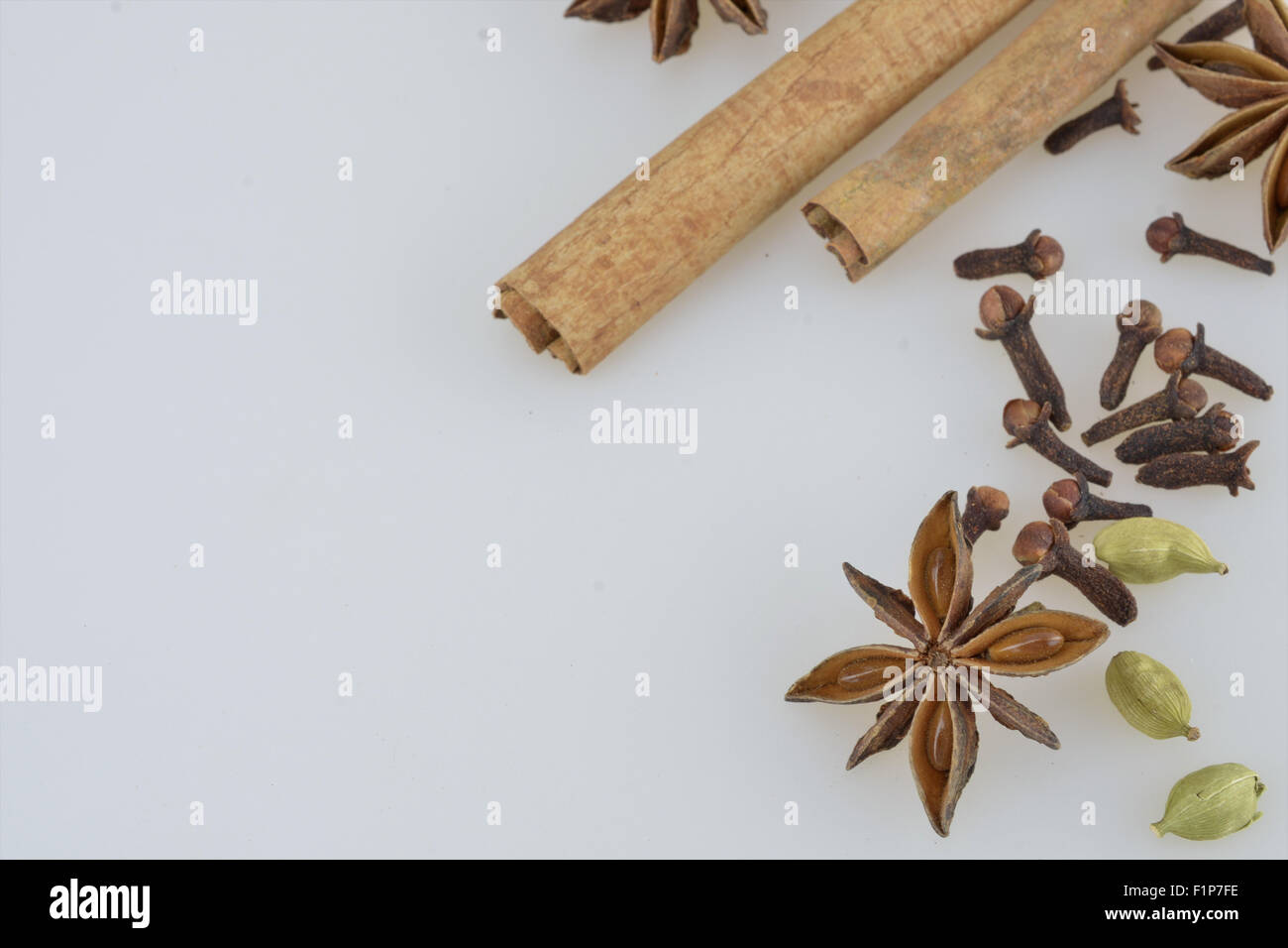 Right corner border of spices including cinnamon, cloves, coriander and ...