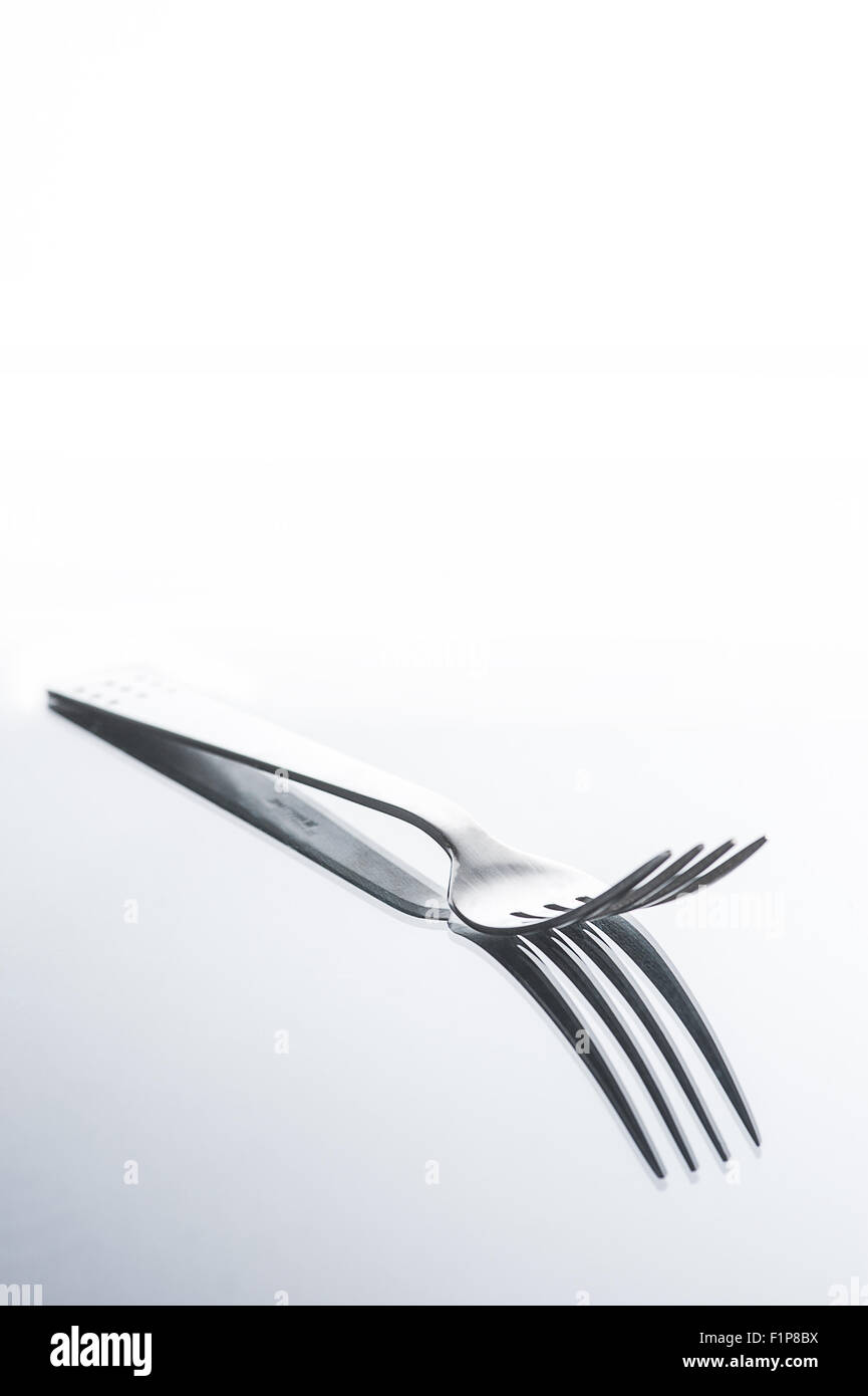 Still life image of a fork on a reflective surface Stock Photo - Alamy