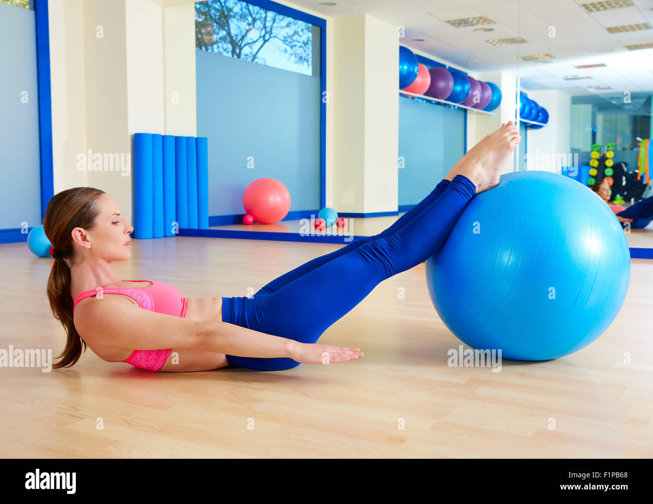 Pilates woman hundred fitball exercise workout at gym indoor swiss ball ...