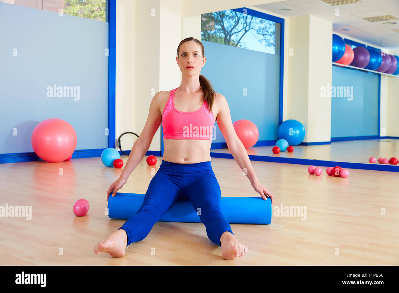 Pilates woman roller sit roll exercise workout at gym indoor Stock ...