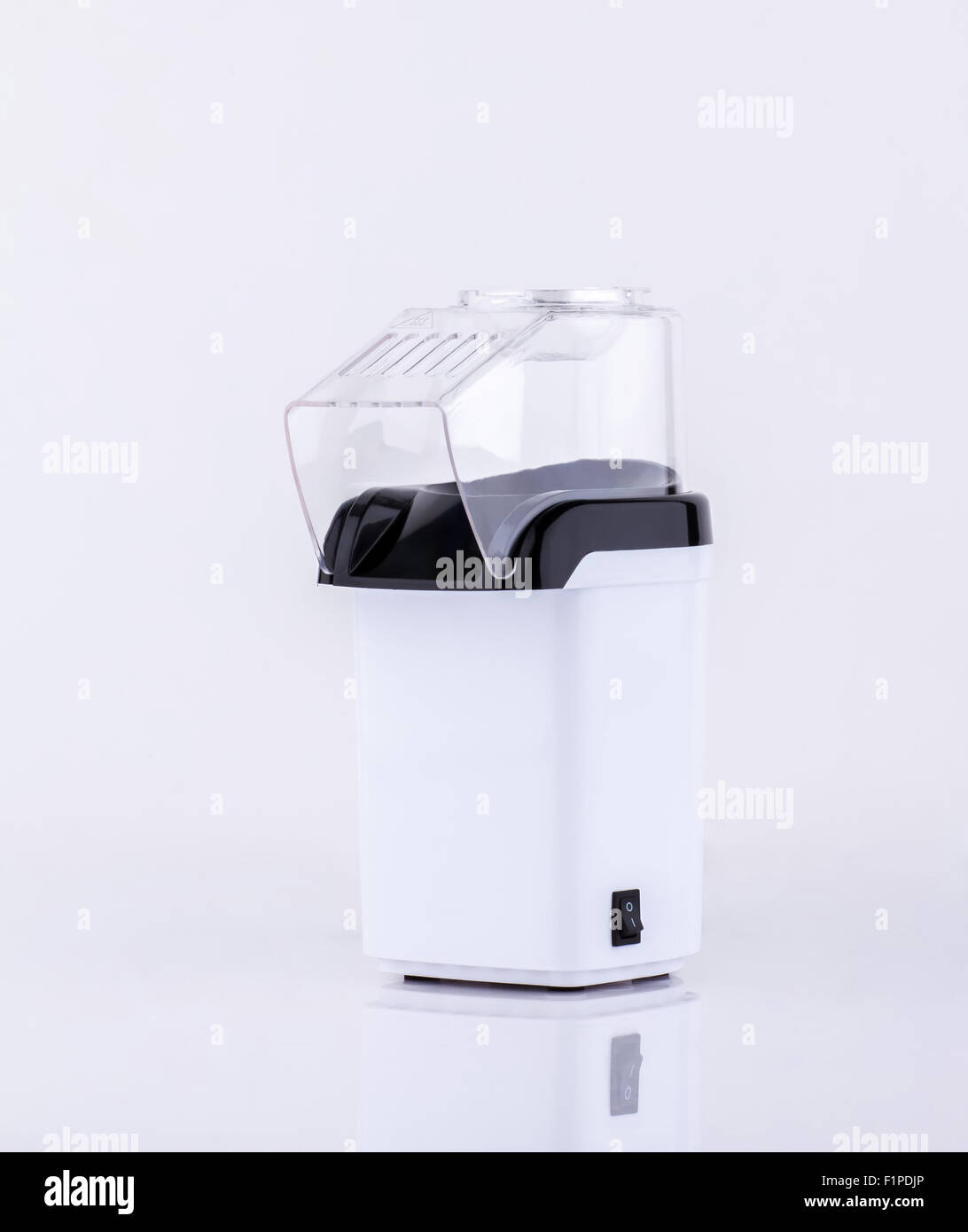 Popcorn making machine isolated on white background Stock Photo - Alamy