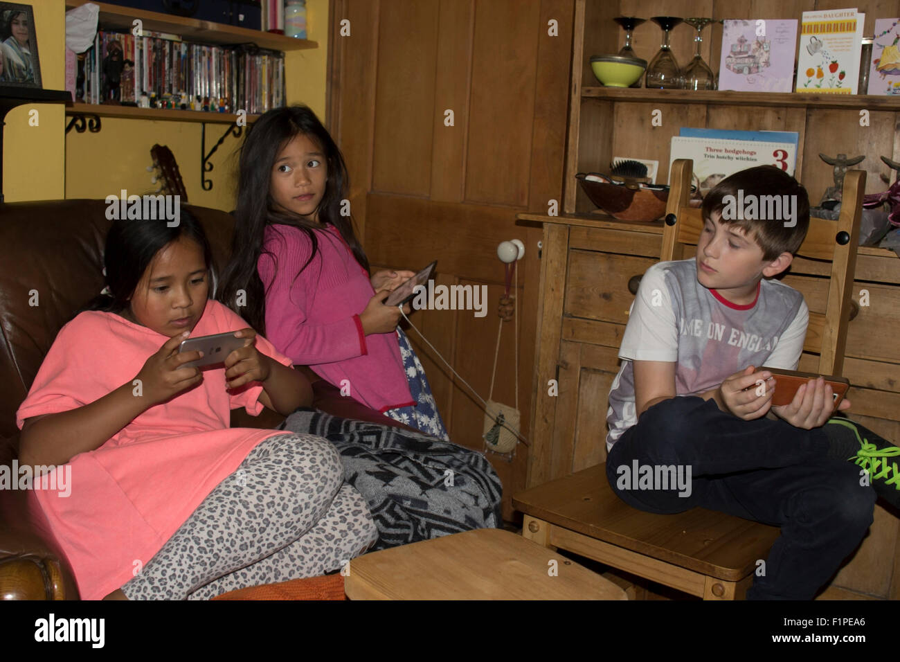 Young children playing on mobile phones Stock Photo - Alamy