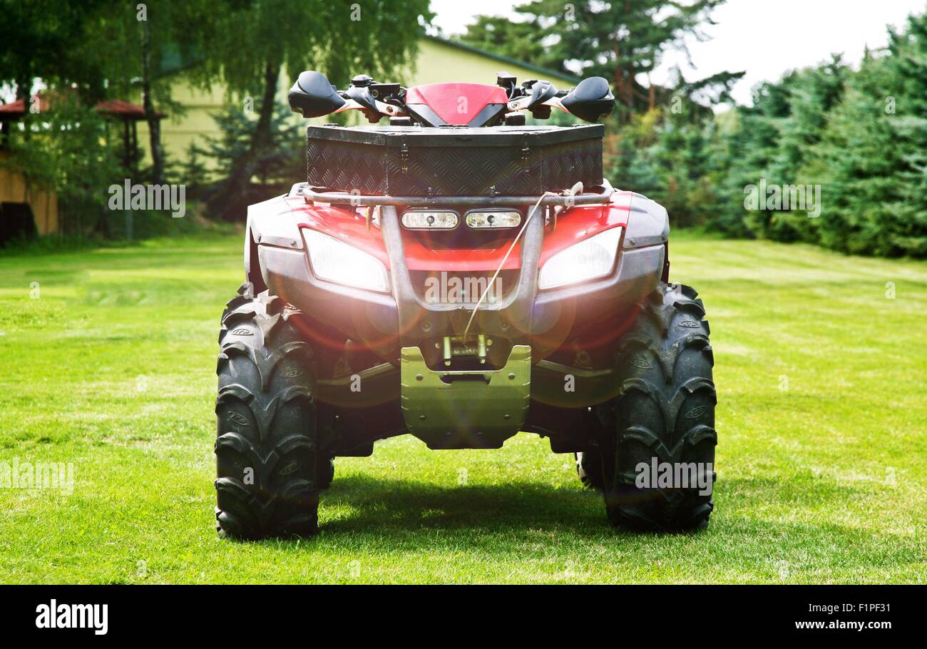 ATV ( All Terrain Vehicle ) - Quad Bike on the Back Yard. Headlights On ...