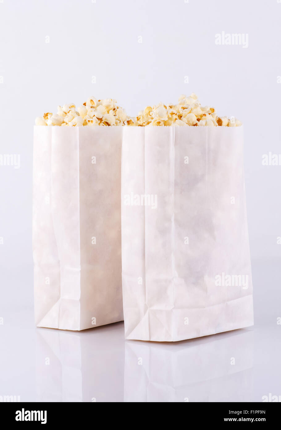 Popcorn in paper bags isolated on white background Stock Photo - Alamy