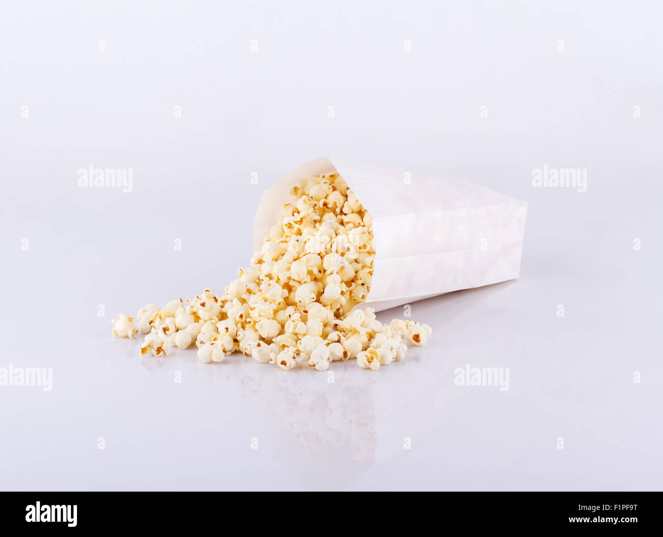 Popcorn in paper bag spread isolated on white background Stock Photo ...