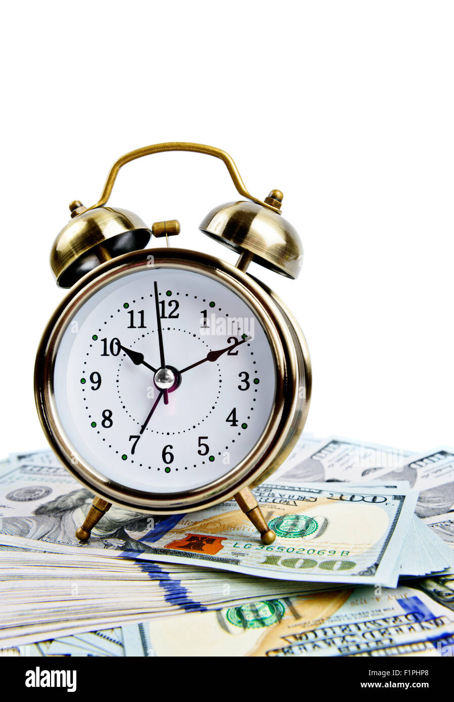 Vintage alarm clock over money Stock Photo - Alamy
