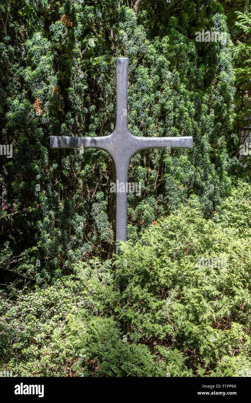 Metal cross with trees and shrubs Stock Photo - Alamy
