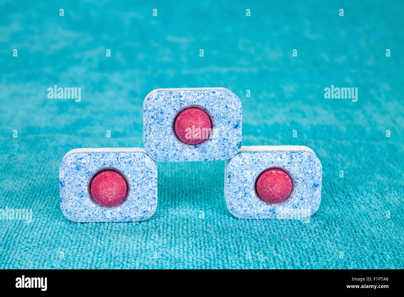 Group of three modern chemical tablets for dishwasher Stock Photo - Alamy