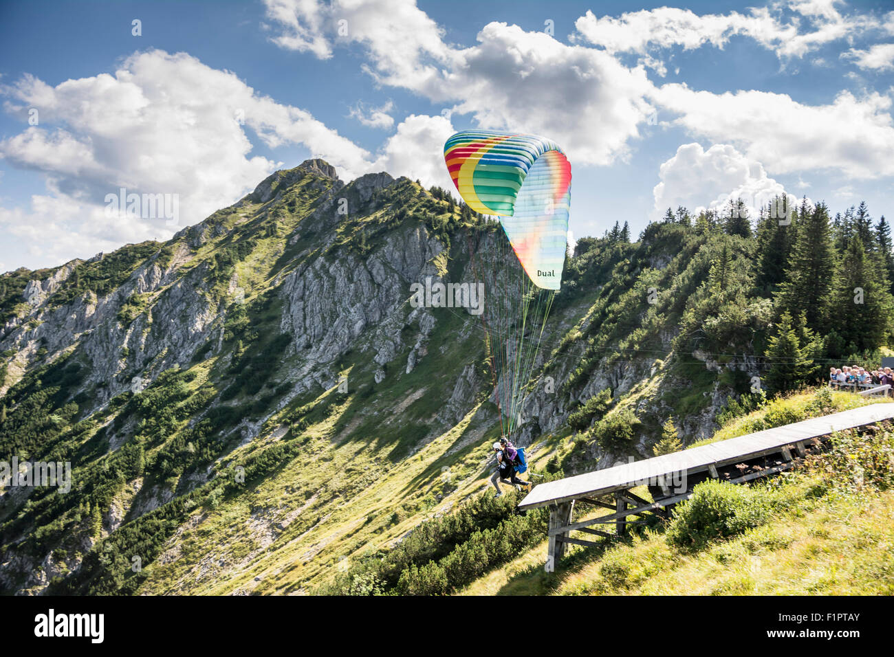SCHWANGAU, GERMANY - AUGUST 23: Unknown paraglider on mount Tegelberg ...