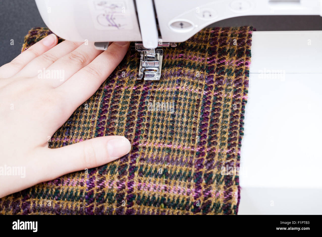 sewer hand and foot of sewing machine on woolen tissue close up Stock ...