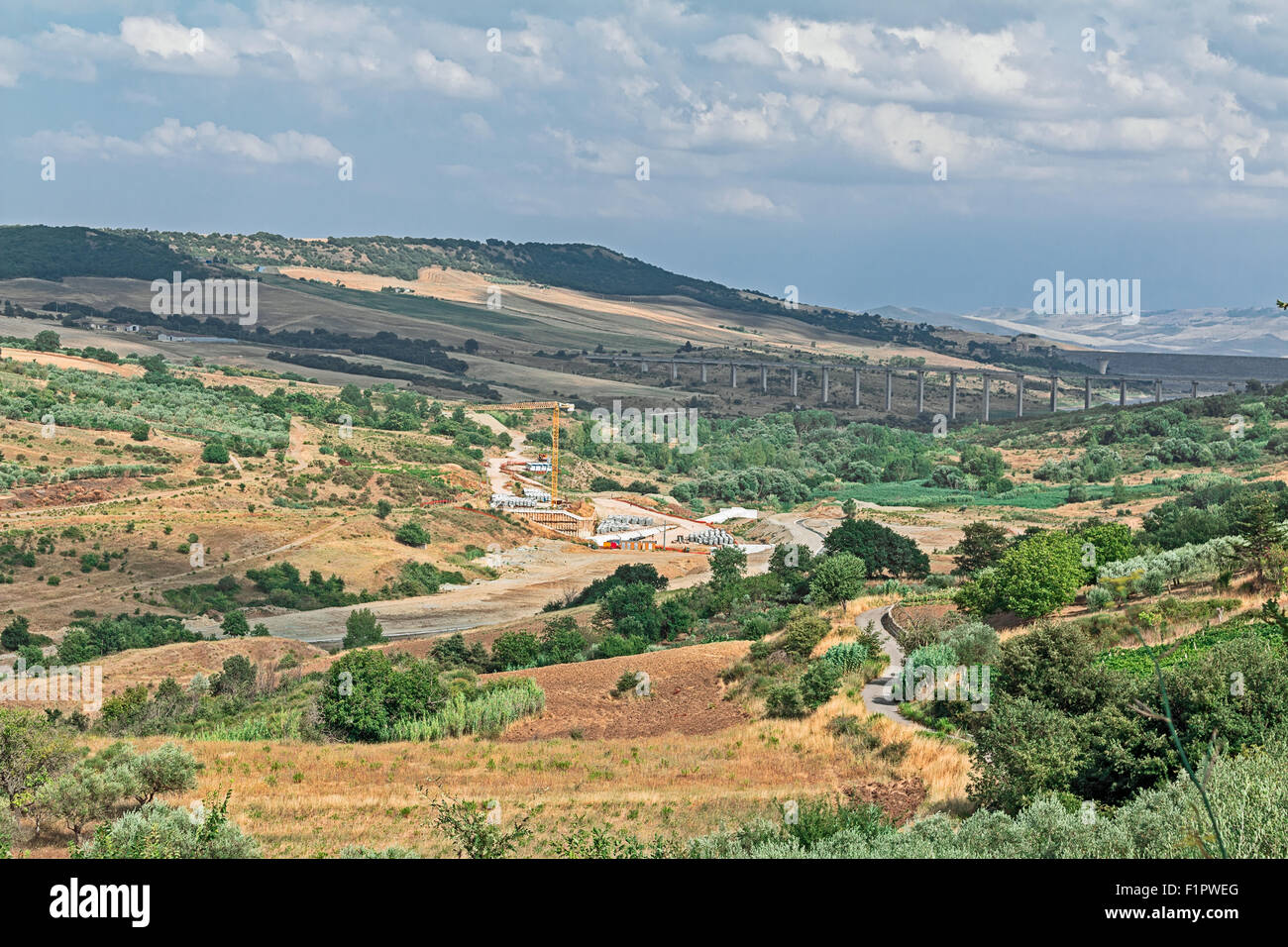 green landscape of valley with a bridge and crane Stock Photo - Alamy