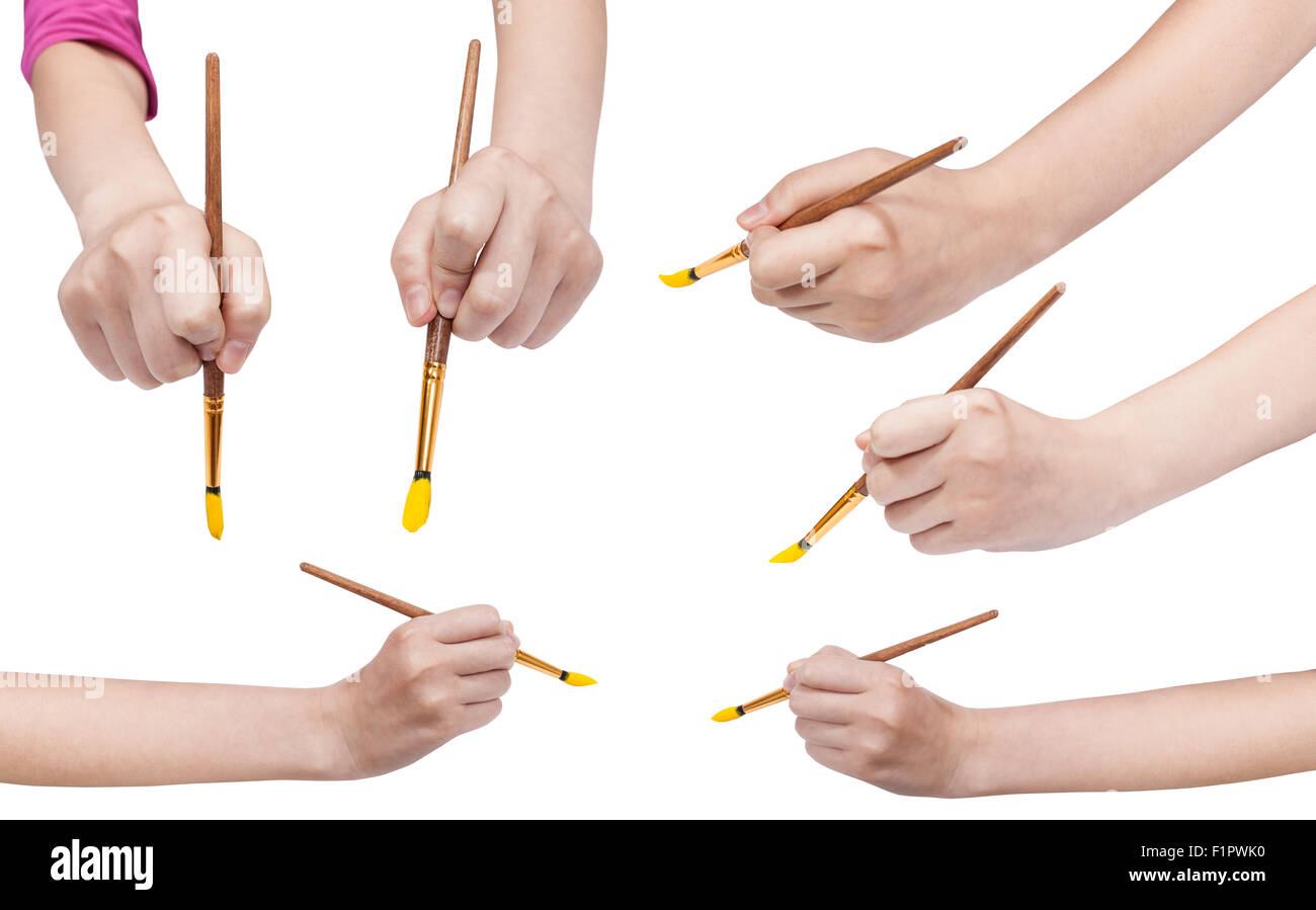 set of hands with round art paintbrushes with yellow painted tips ...