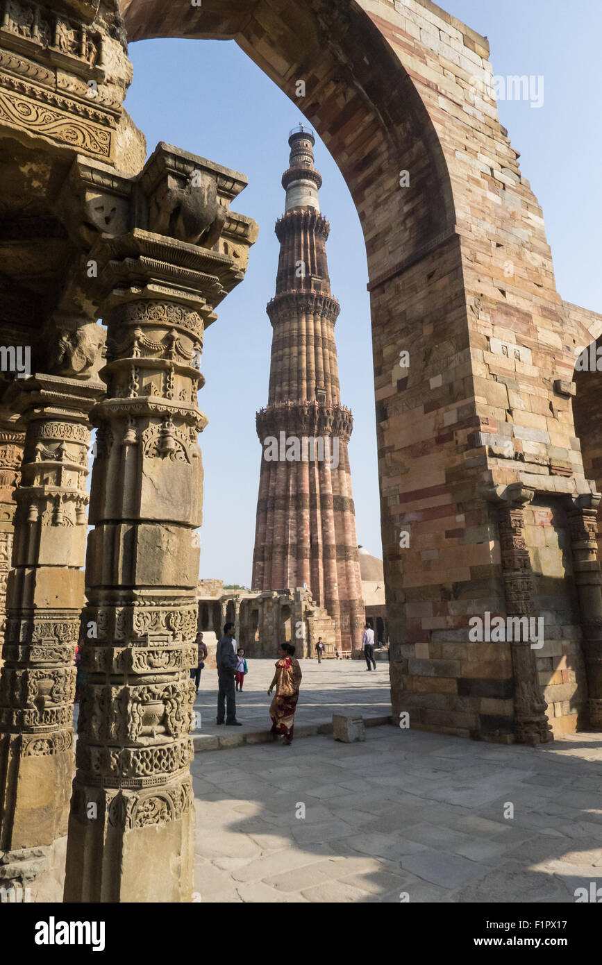 Delhi, India. The Qutub Minar tower viewed throughan arch from the ...