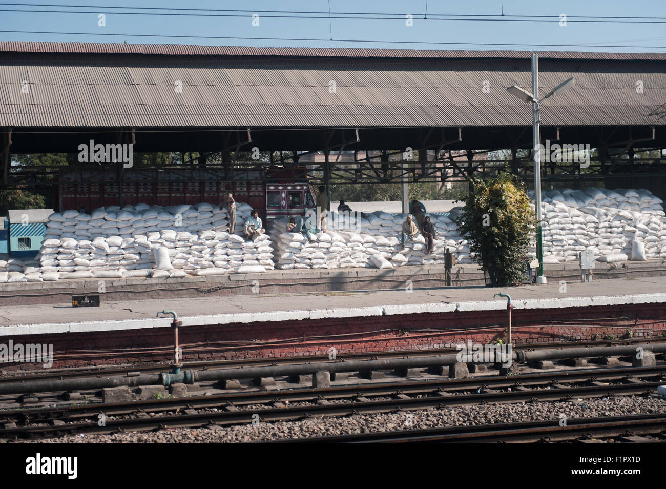 Amritsar, Punjab, India. Rice bags stacked on a platform at the station ...