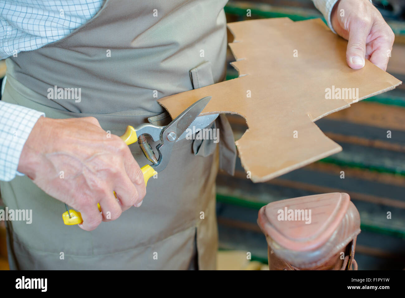 Cobbler cutting out new sole for shoe Stock Photo - Alamy