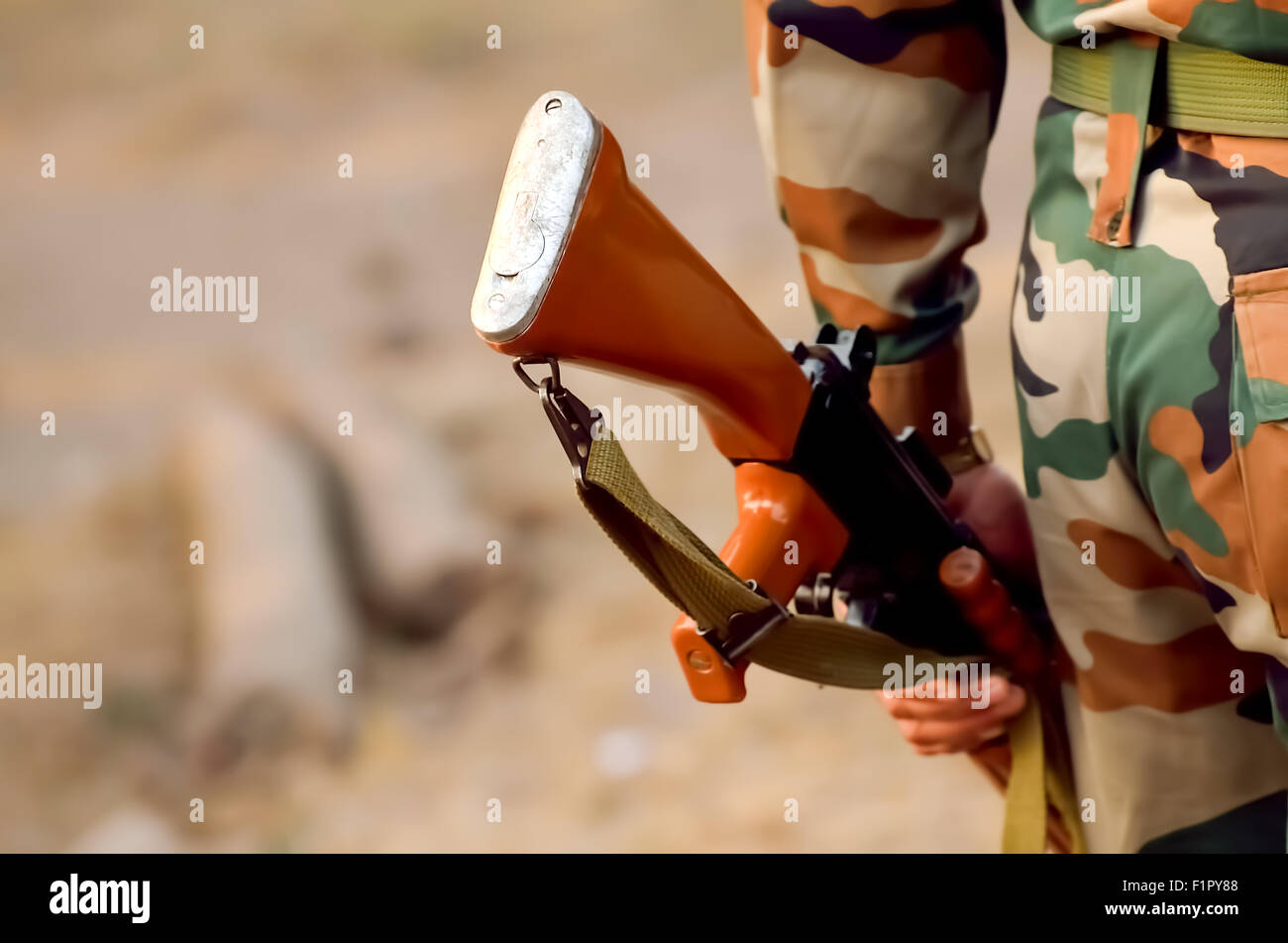 Soldier hiding AK-47 Stock Photo - Alamy