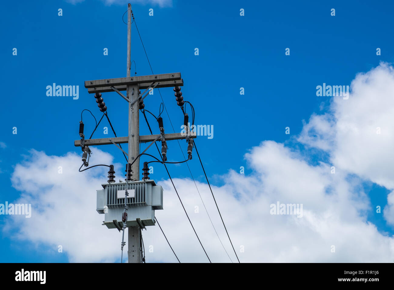 Electricity post and telephone line with blue sky Stock Photo - Alamy