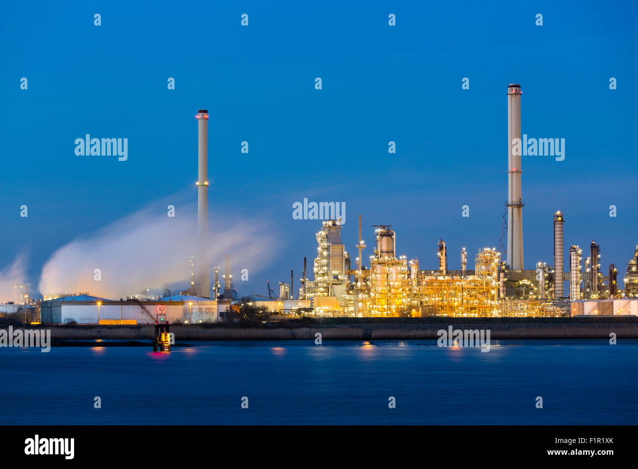 View over the Scheldt river in Antwerp, Belgium to a large oil refinery ...