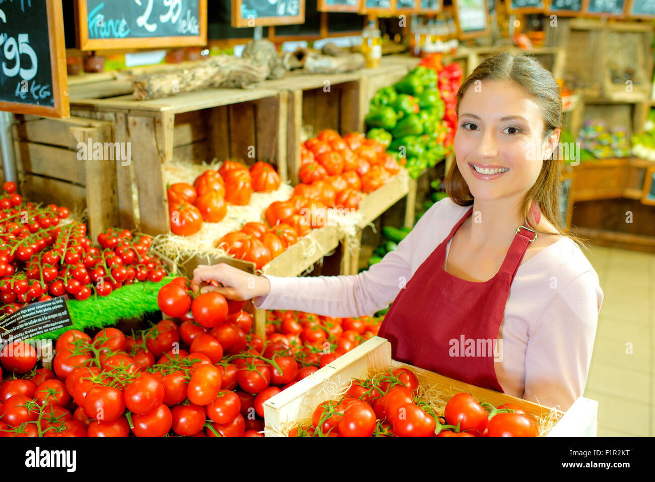 Supermarket worker stocking the vegetable aisle Stock Photo - Alamy