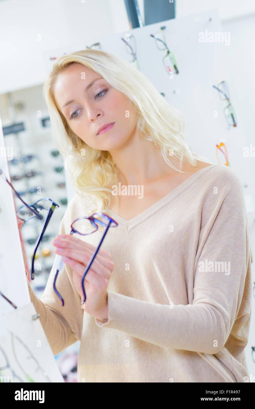 Lady comparing spectacles Stock Photo - Alamy