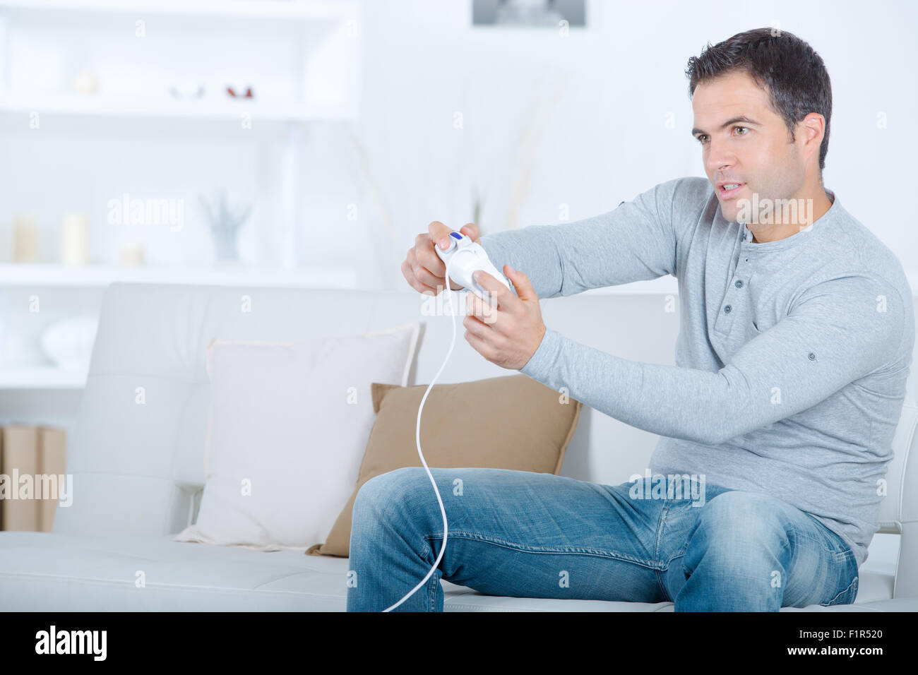 Guy playing a video game Stock Photo - Alamy