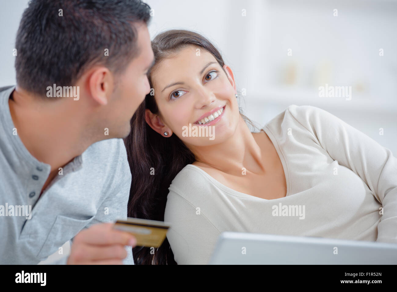 Couple with computer and credit card Stock Photo - Alamy