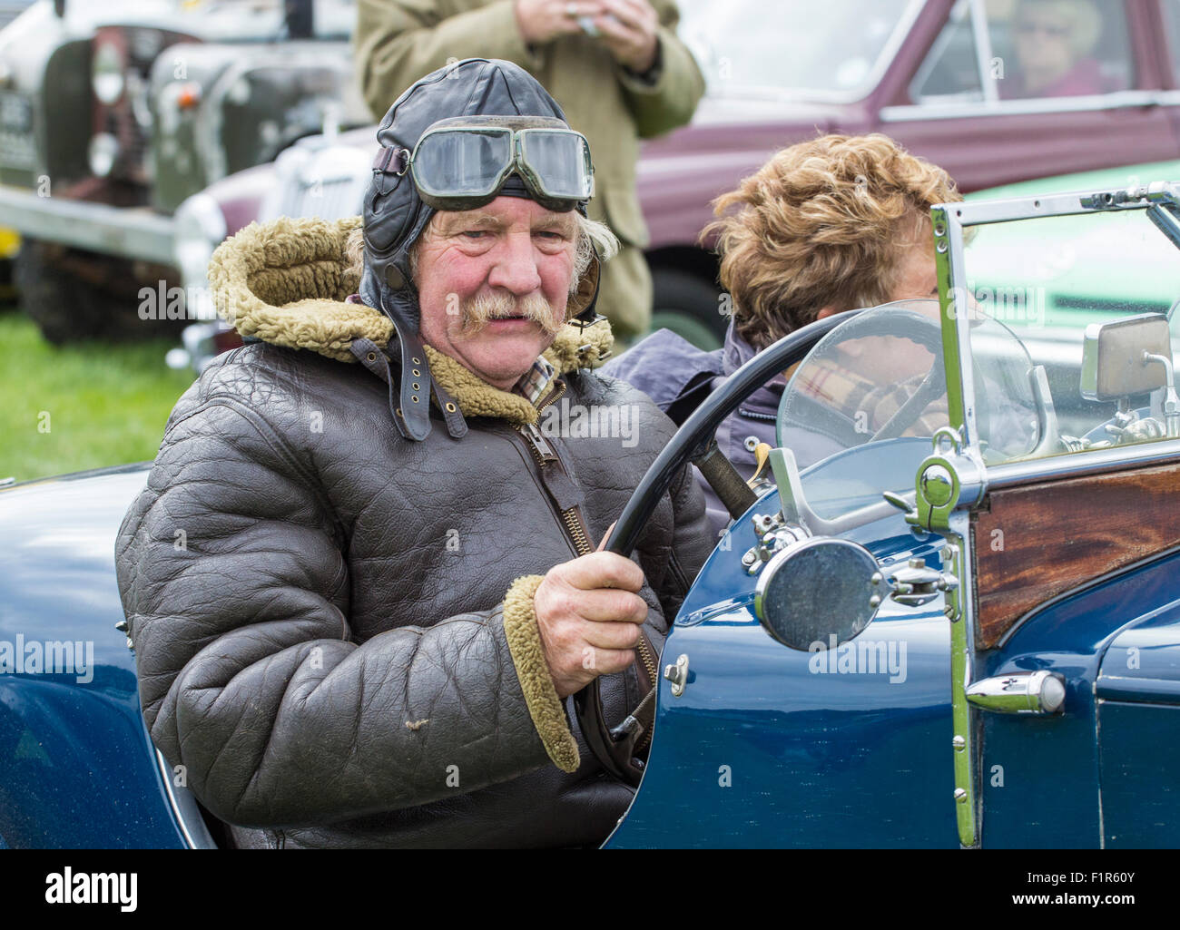 Man driving a 1936 Riley Merlin Special classic car at counrty show. UK ...