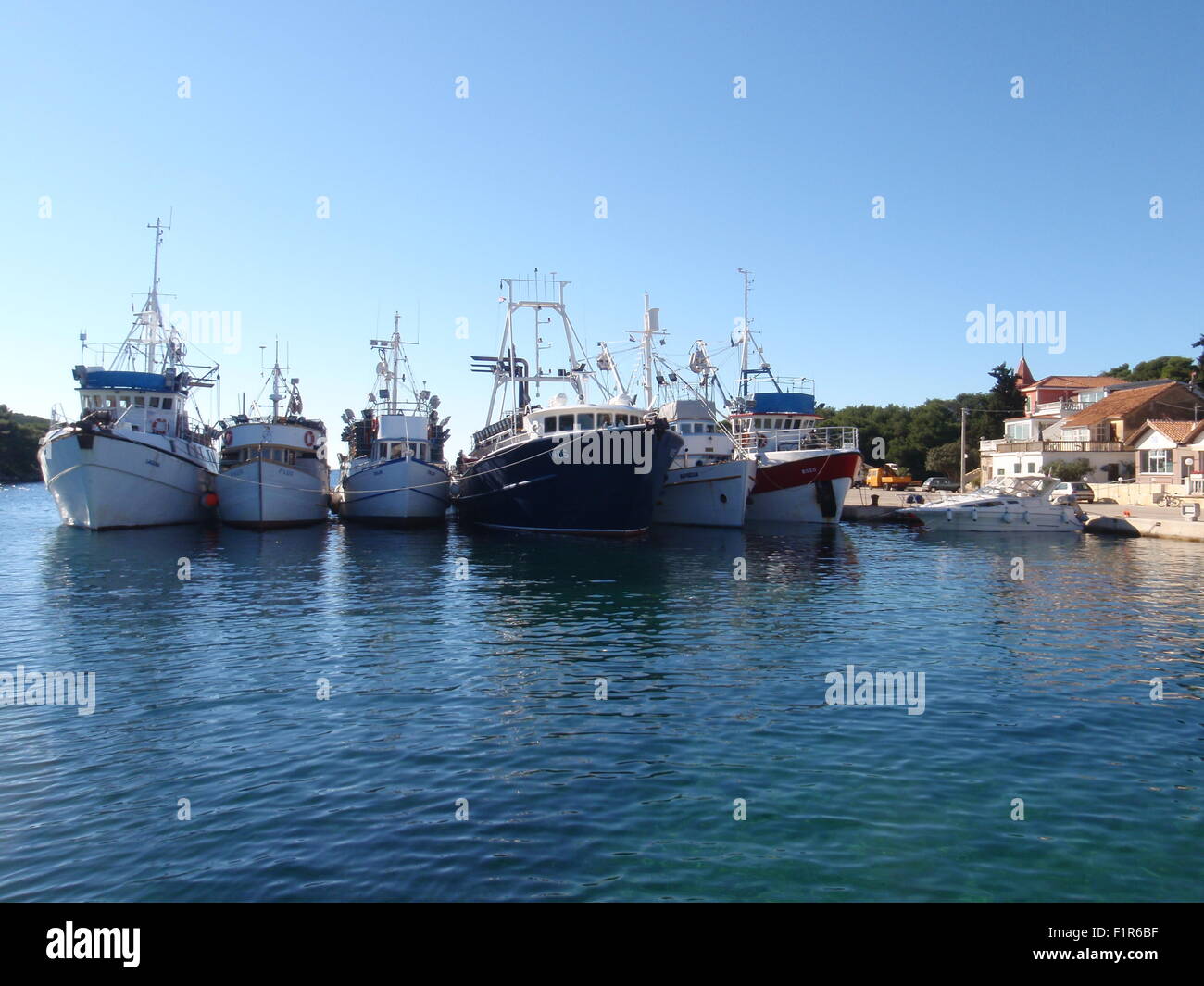 Large fishing boats docked because of storm Stock Photo - Alamy