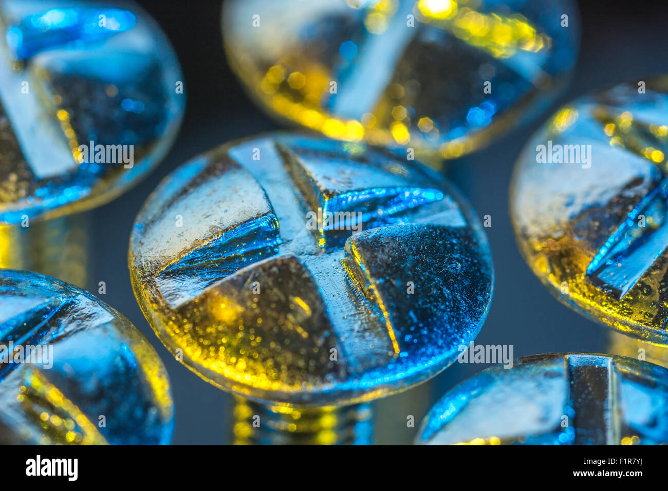 Set of bolt heads taken under artificial lighting. Macro-photo Stock ...