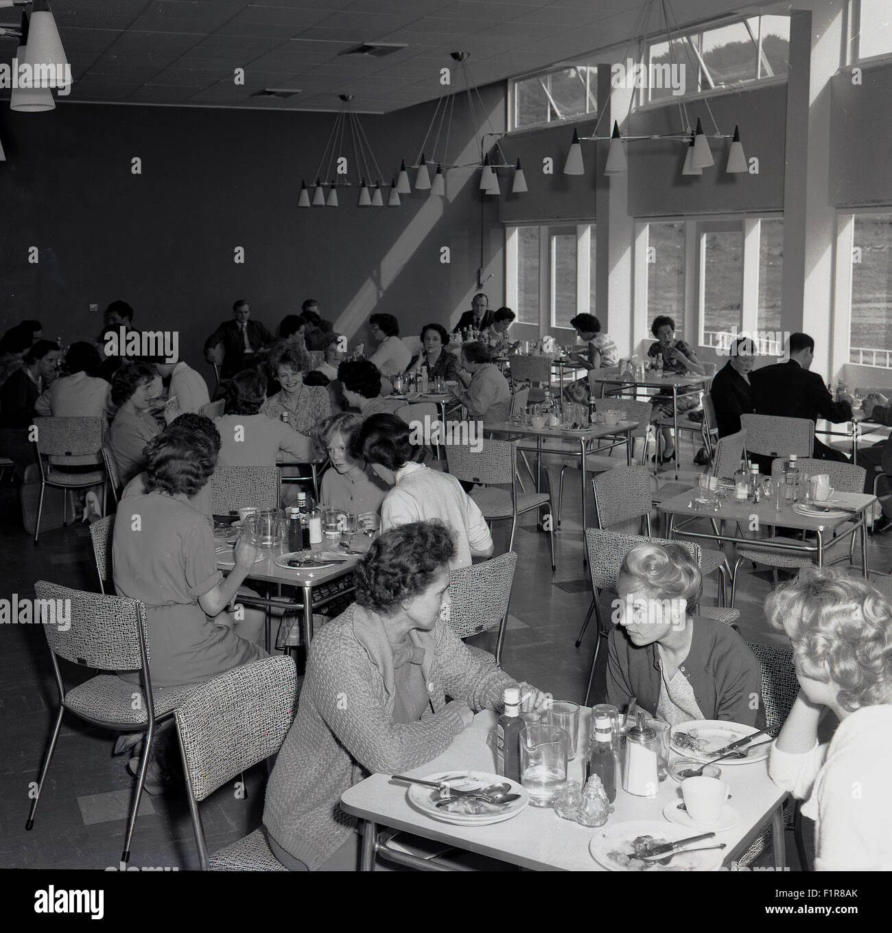 Historical, 1950s, picture of workers or employees having lunch in the ...