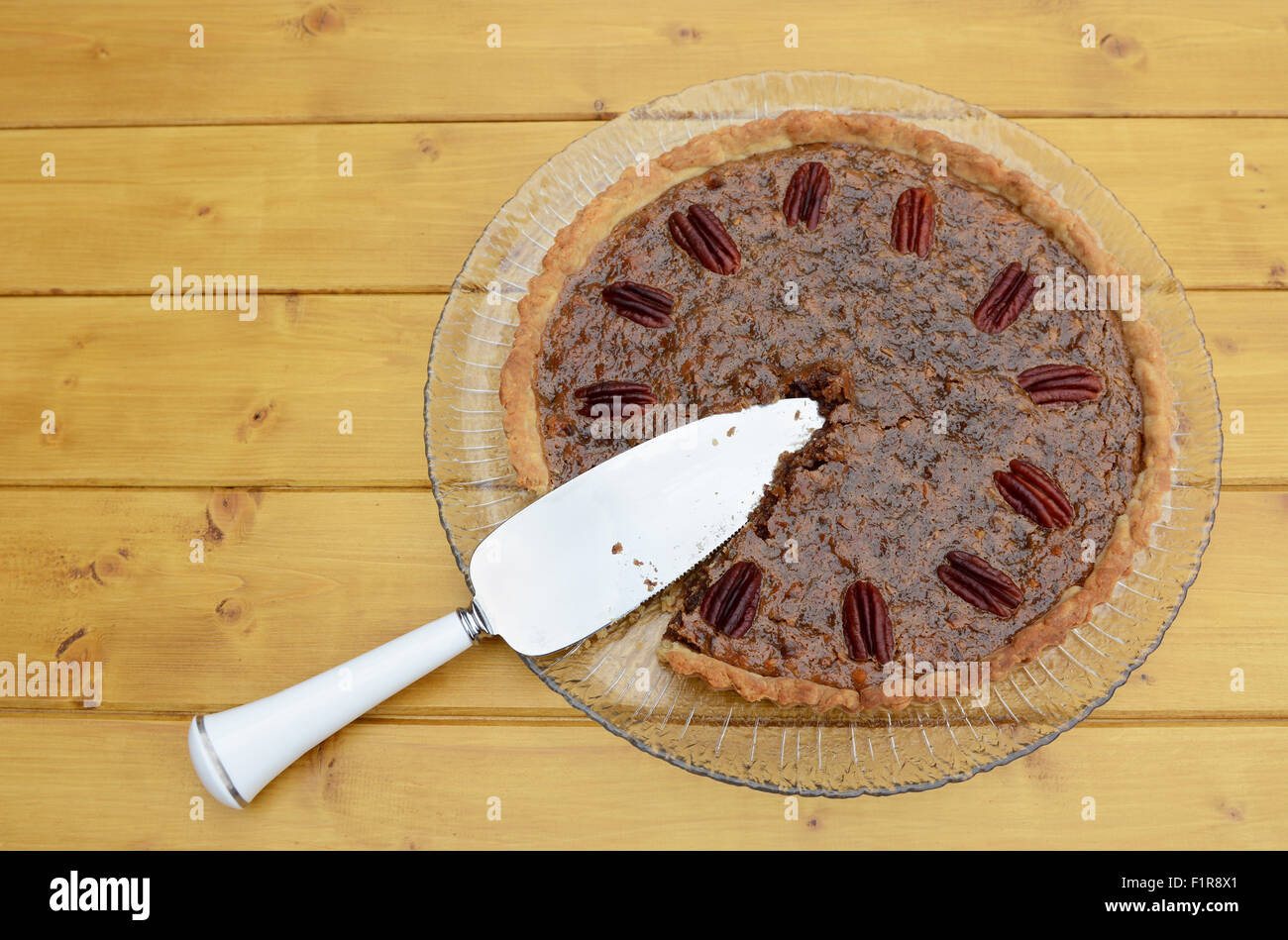 Pie server in a sliced home-made pecan pie on a wooden table Stock ...