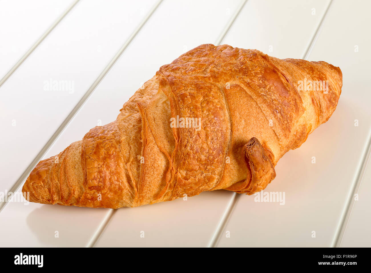 Sweet Croissant with chocolate on white wooden background Stock Photo ...