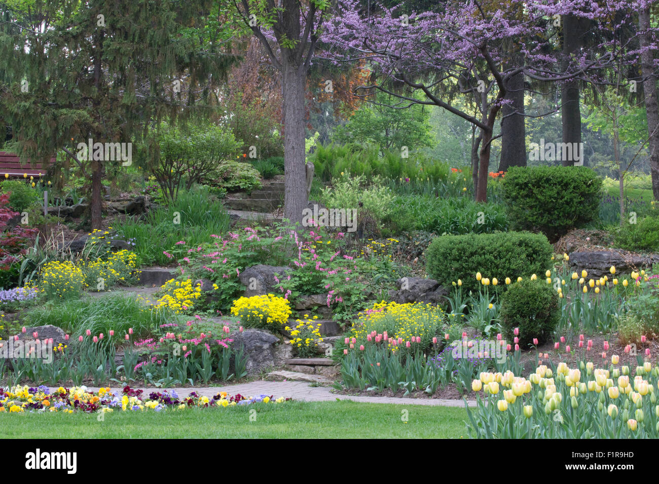 Beautiful garden scene with profusion of spring flowers Stock Photo - Alamy