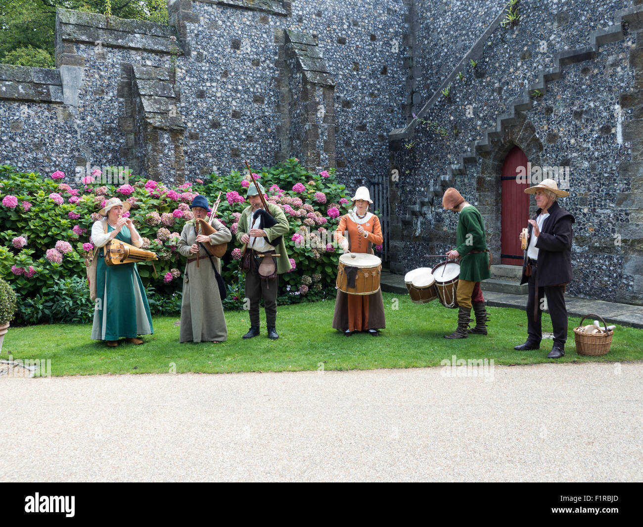 Medieval minstrels playing music within the castle walls Stock Photo ...
