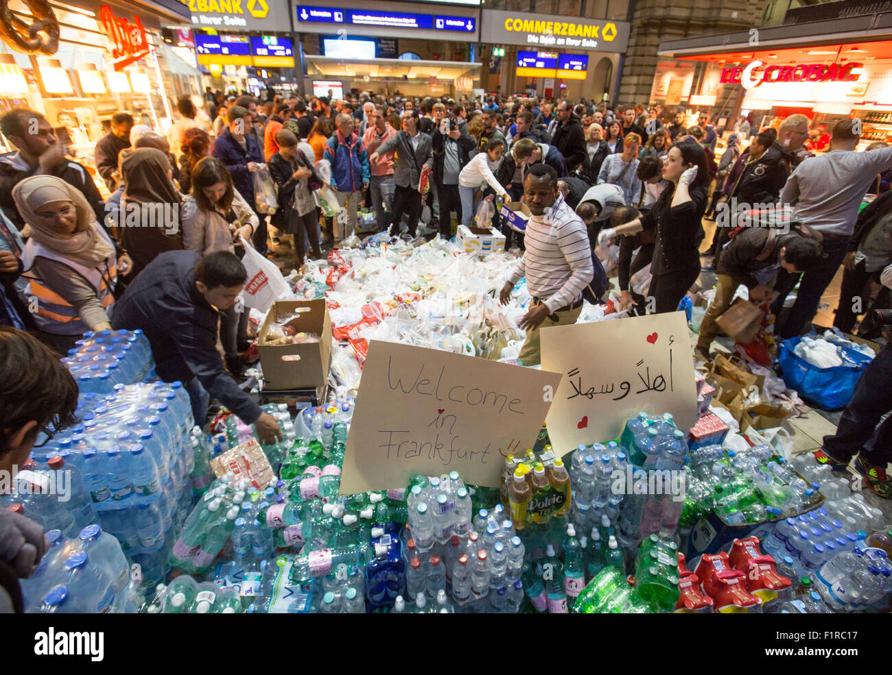 Volunteers prepare for the arrival of refugees with food, drinks and ...