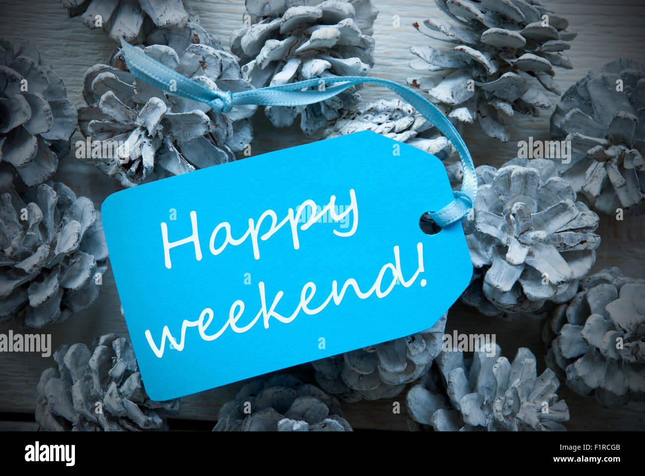 Light Blue Label On Fir Cones With Happy Weekend Stock Photo - Alamy